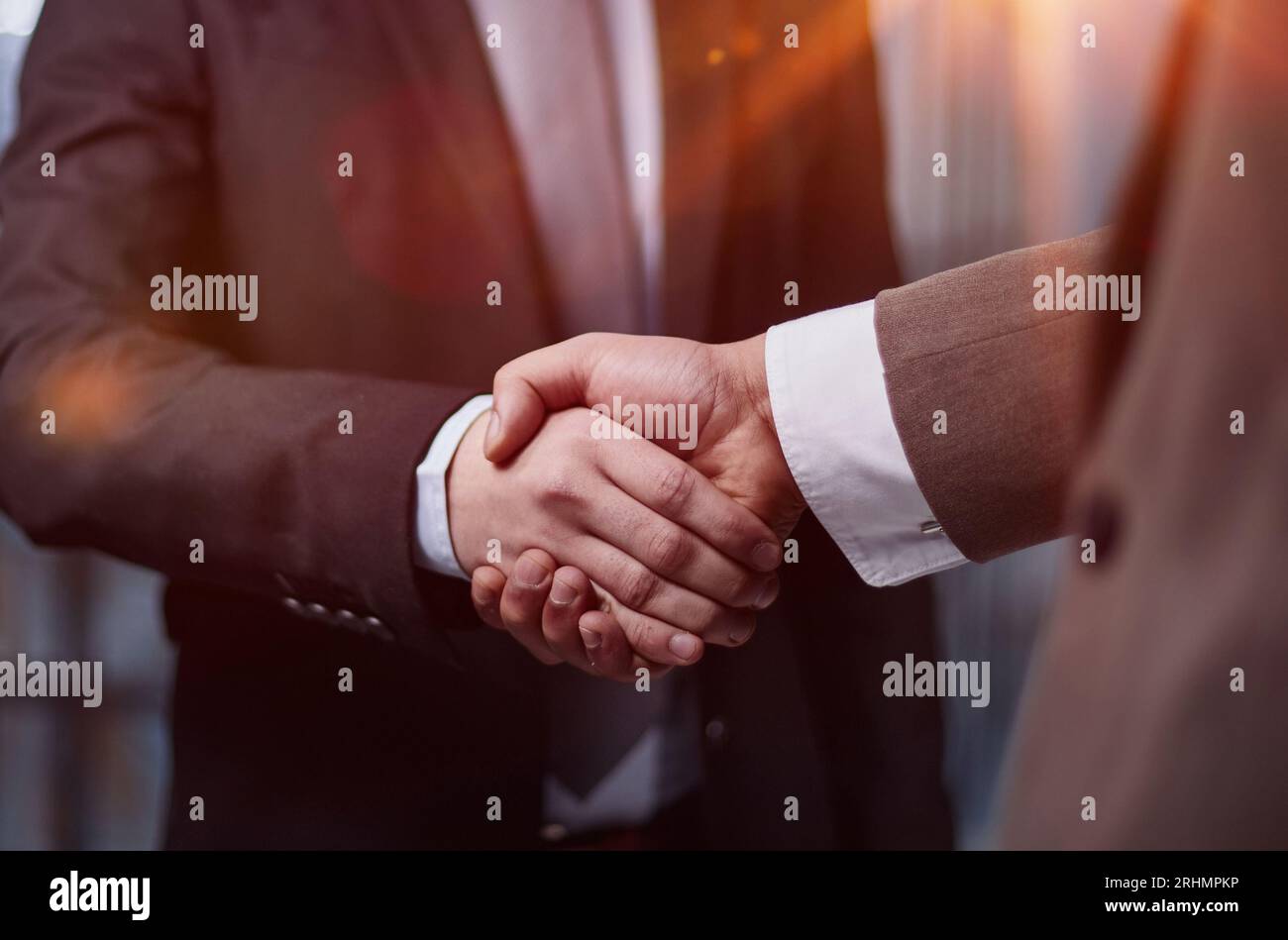 employees greeting each other with a handshake in the office corridor ...