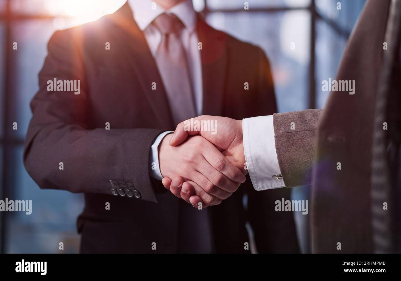 employees greeting each other with a handshake in the office corridor Stock Photo - Alamy