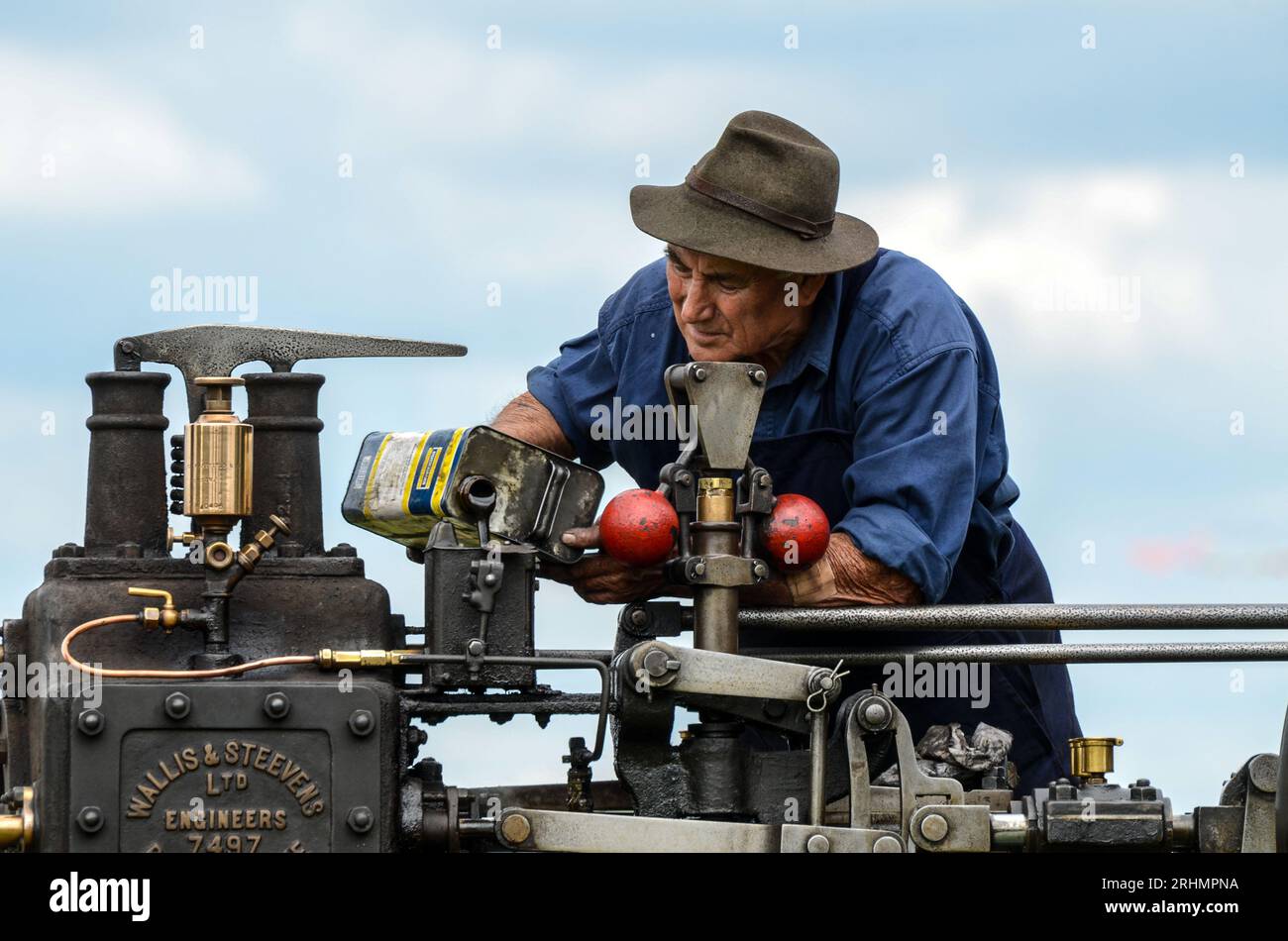 Senior Caucasian male pouring oil into the mechanism of a Wallis ...