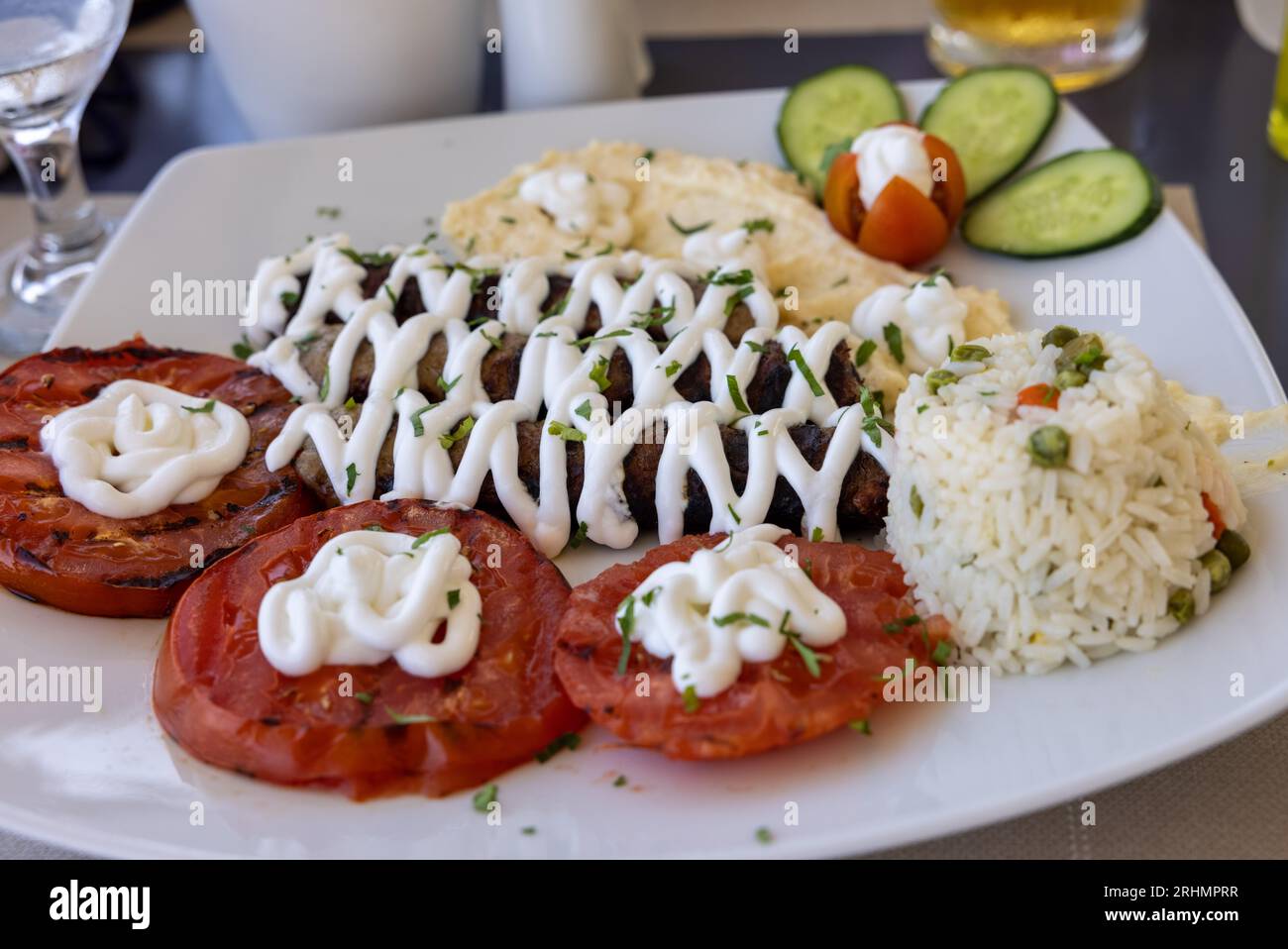 Fried souvlaki and grilled tomatoes. Typical delicious greek style ...
