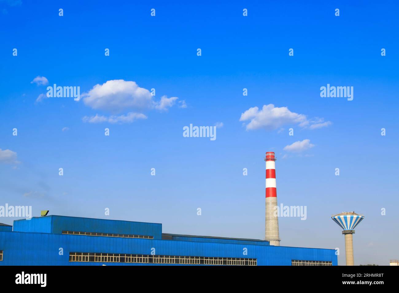 chimneys and water towers, industrial plant in the blue sky, north ...