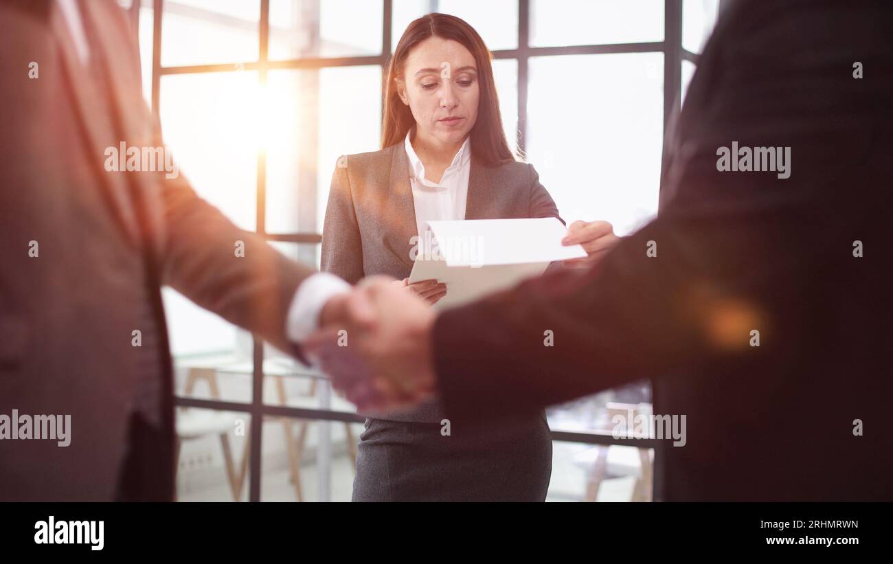 mature workers shaking hands in partnership deal, collaboration Stock Photo - Alamy