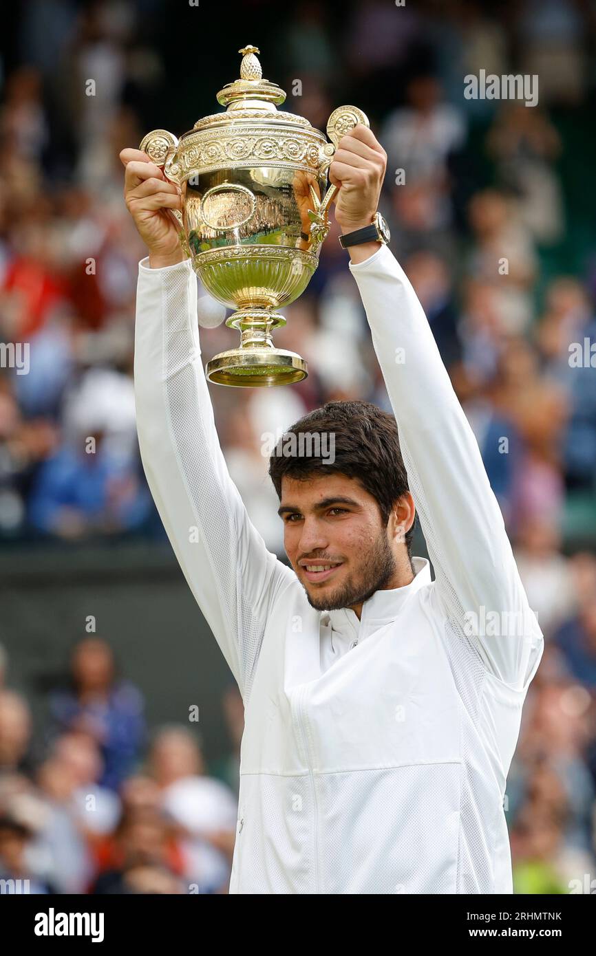 Spanish tennis player Carlos Alcaraz (ESP) lifting up the championship ...