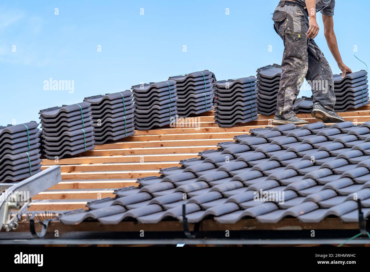 craftsman laying fired ceramic tiles on the roof Stock Photo - Alamy