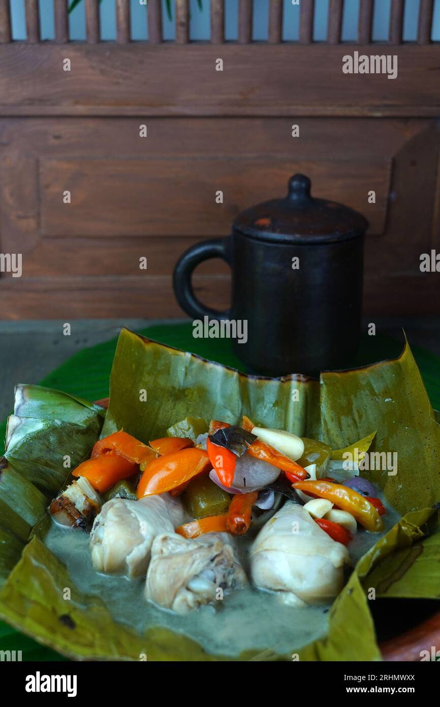 Garang Asem, the traditional Javanese food is served on a clay plate ...