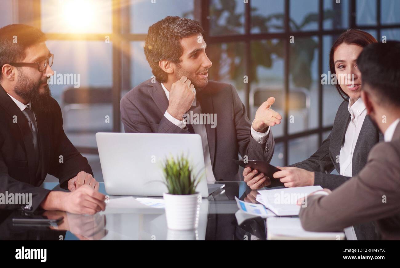 Diverse employees gathered in the office having fun during ...