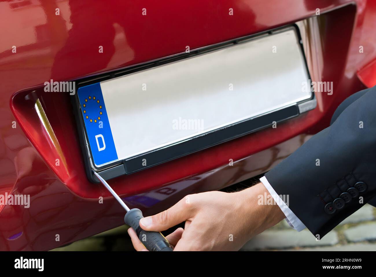 Man Placing New Empty White Number Plate On His Red Car Stock Photo - Alamy