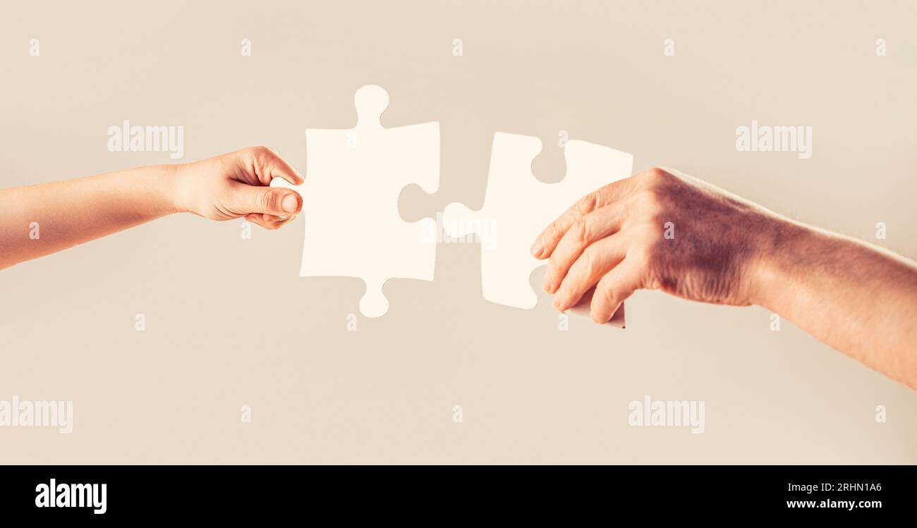 Hands hold puzzles. Solution of problems. Mens and childs hands ...