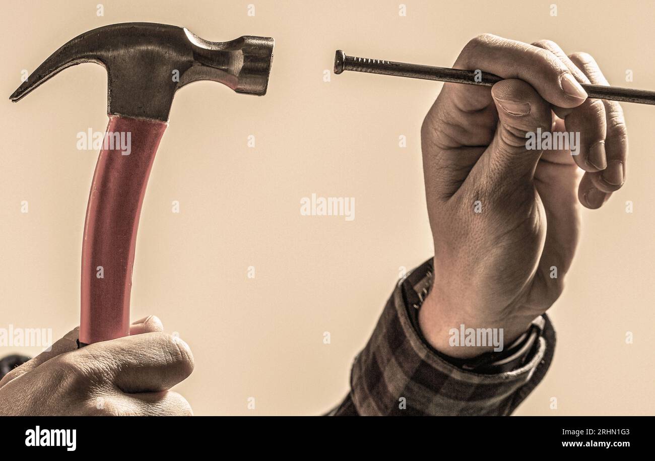Woman hammering a nail hi-res stock photography and images - Alamy