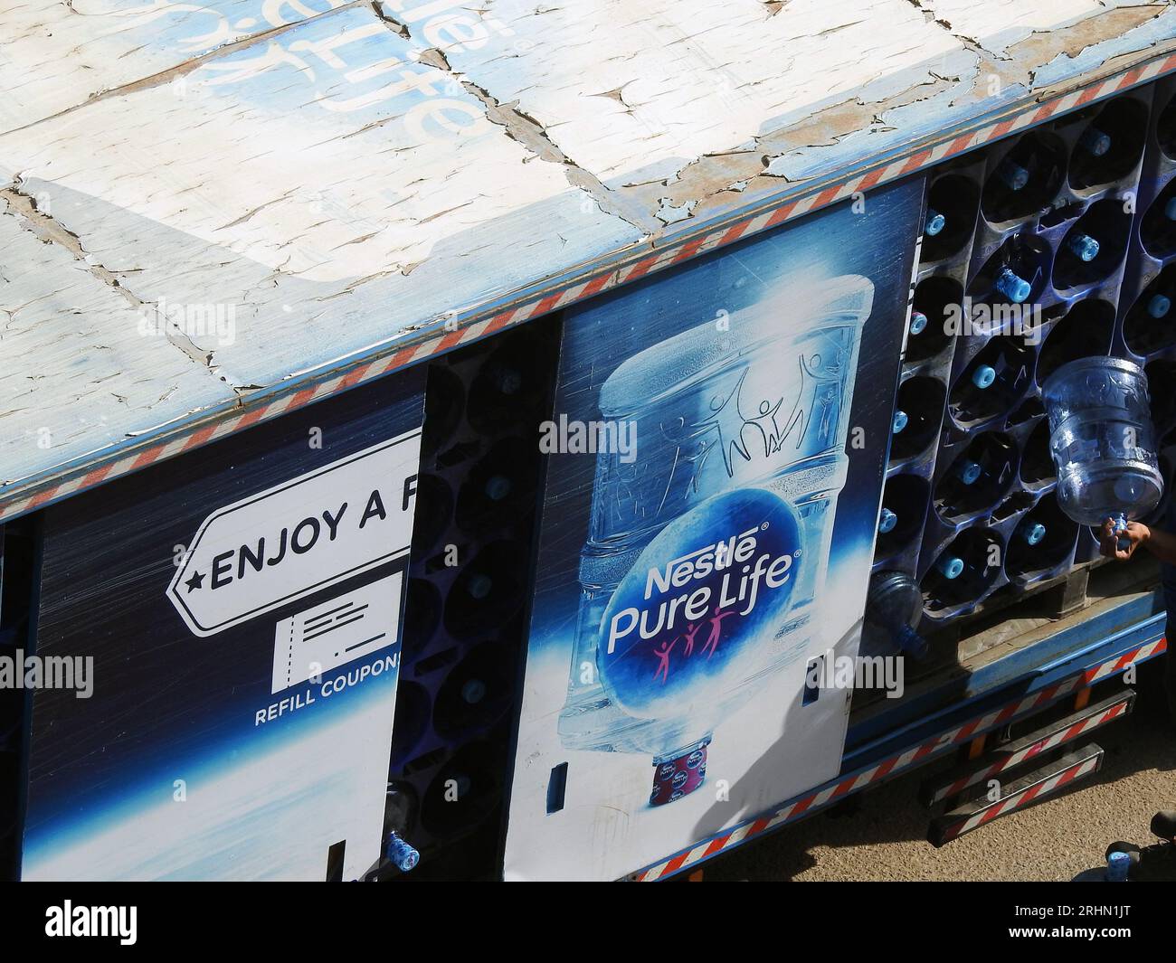 Cairo, Egypt, July 19 2023: Nestle pure Life plastic bottles delivery vehicle, Nestlé S.A., a ...