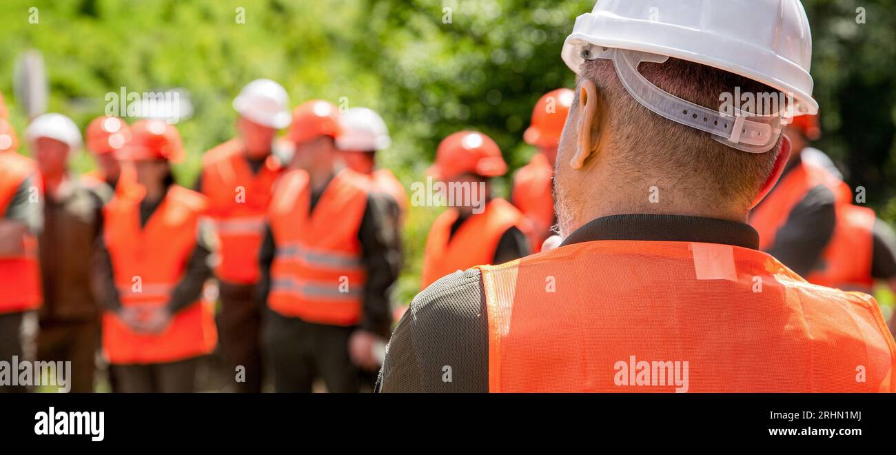 Helmet builder. Many construction workers helmet. Team in hardhat for ...