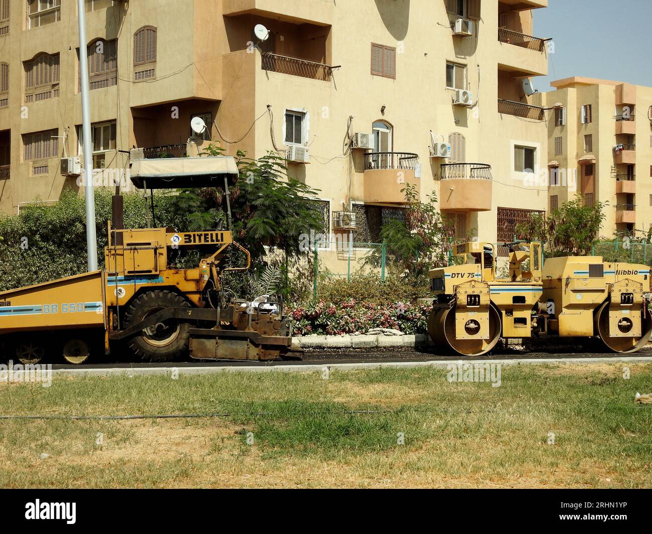 Cairo, Egypt, July 21 2023: Asphalt paver trucks and compactors, A ...