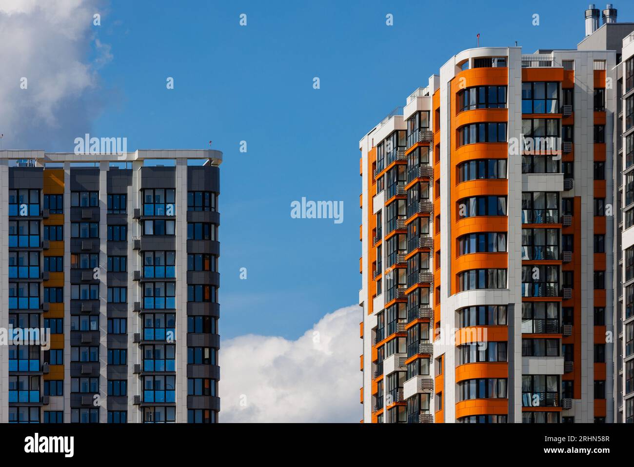 freshly built high rise apartment buildings on blue sky background with ...