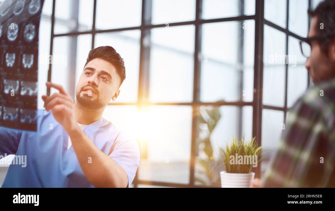 Pensive serious mature adult male physician consult shocked young man ...