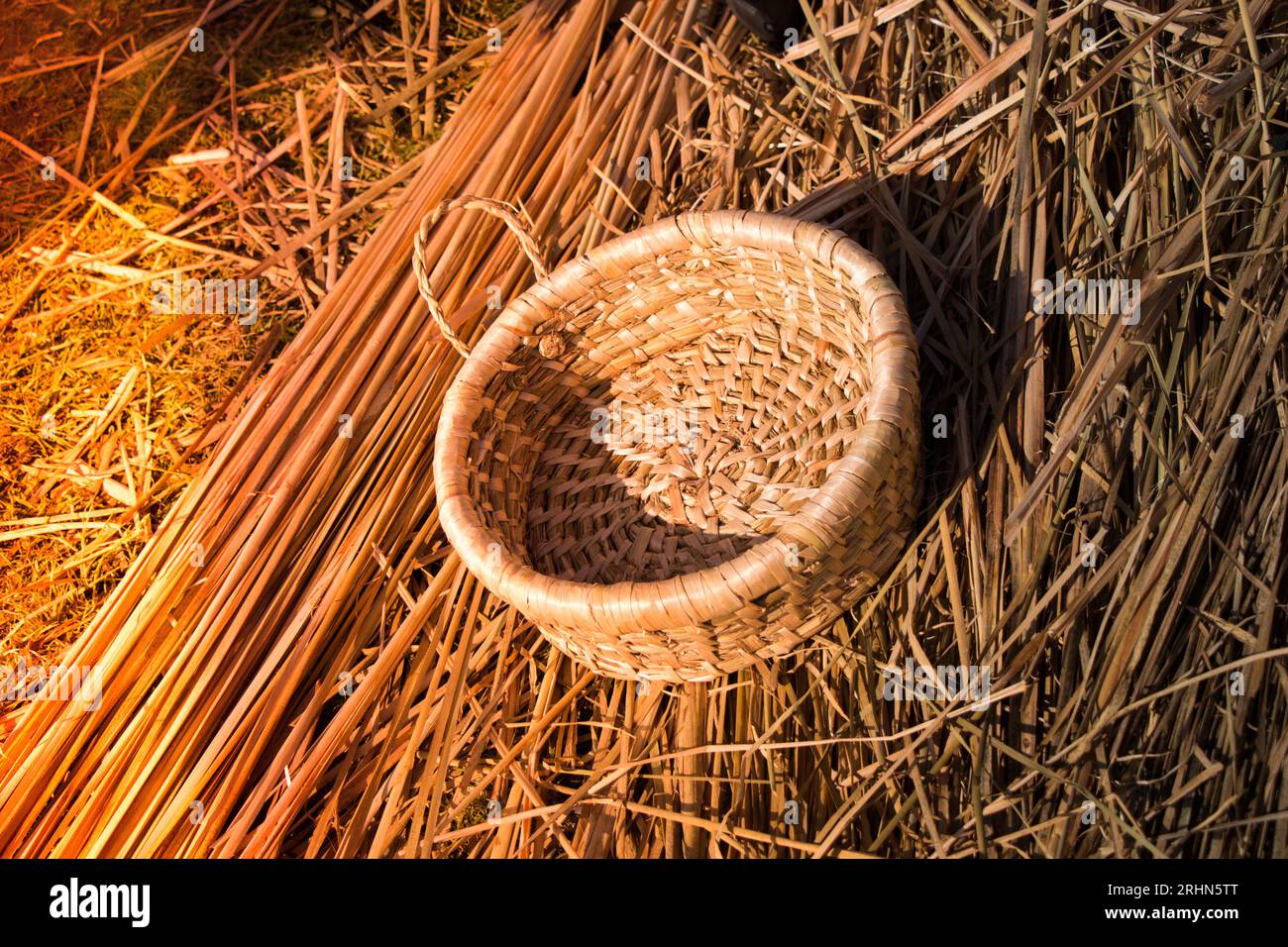 Straw hand made baskets on straw background Stock Photo - Alamy