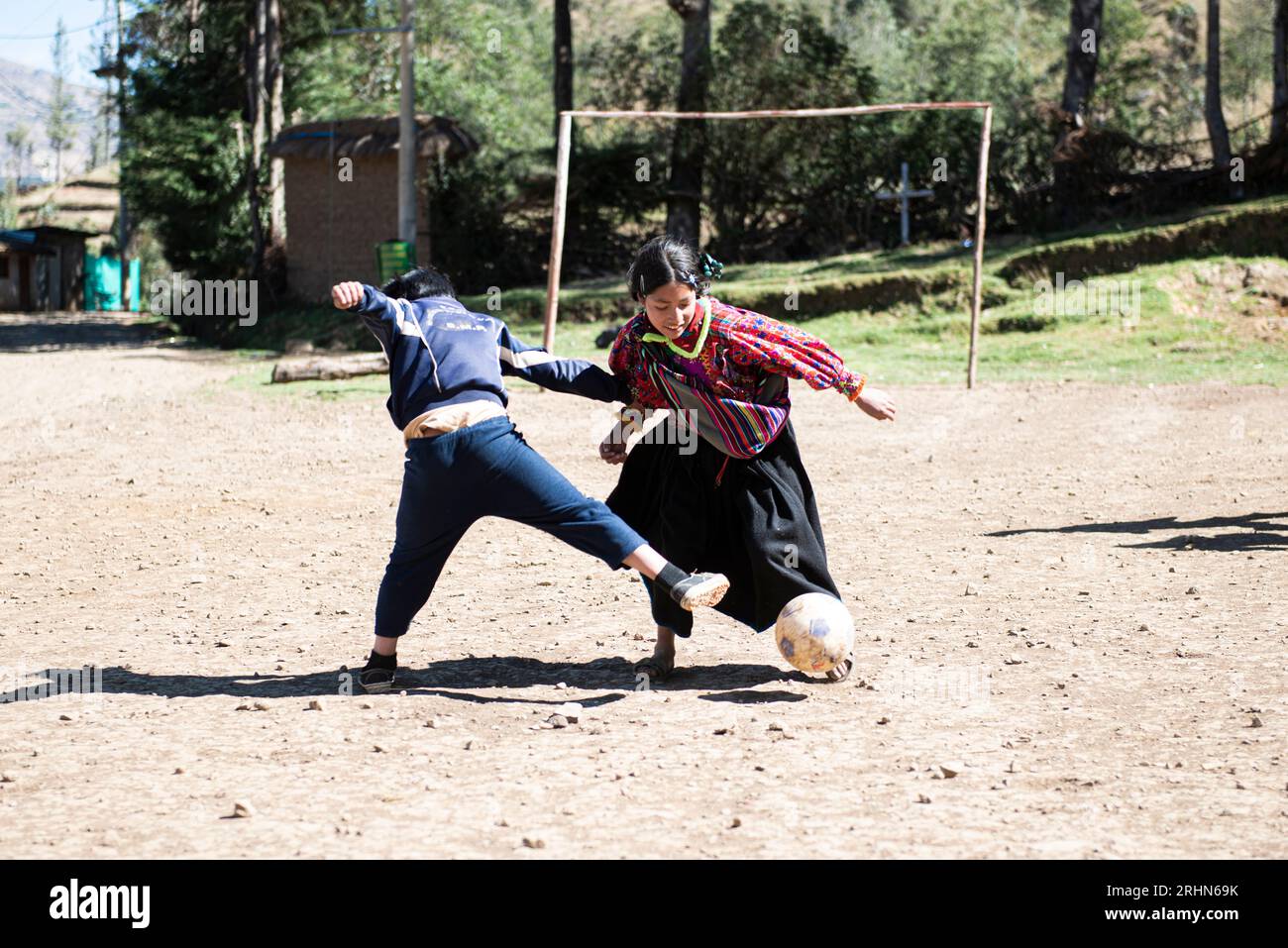 Peruvian girl with colorful clothes playing soccer Stock Photo - Alamy