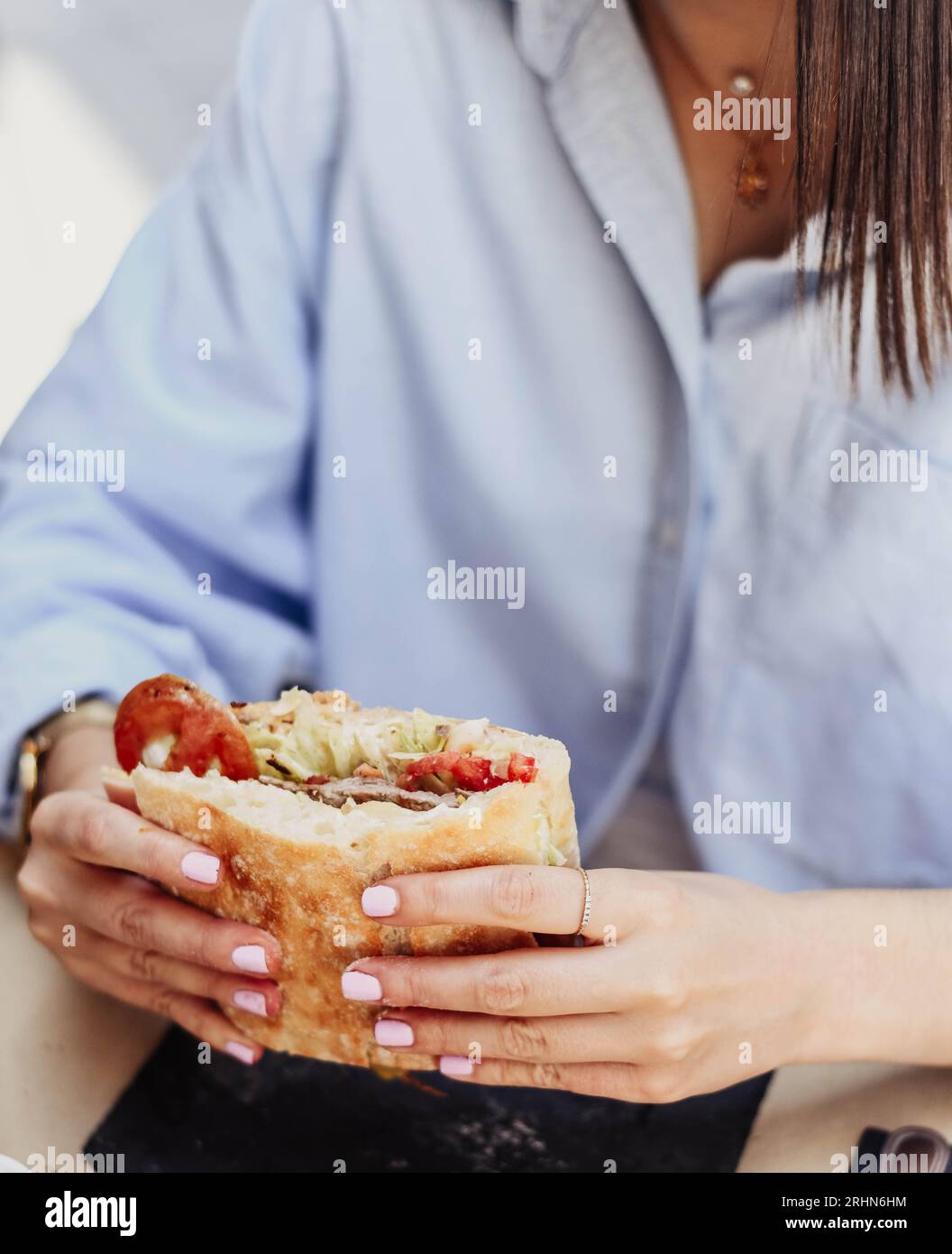 A young person enjoying a beef sandwich Stock Photo - Alamy