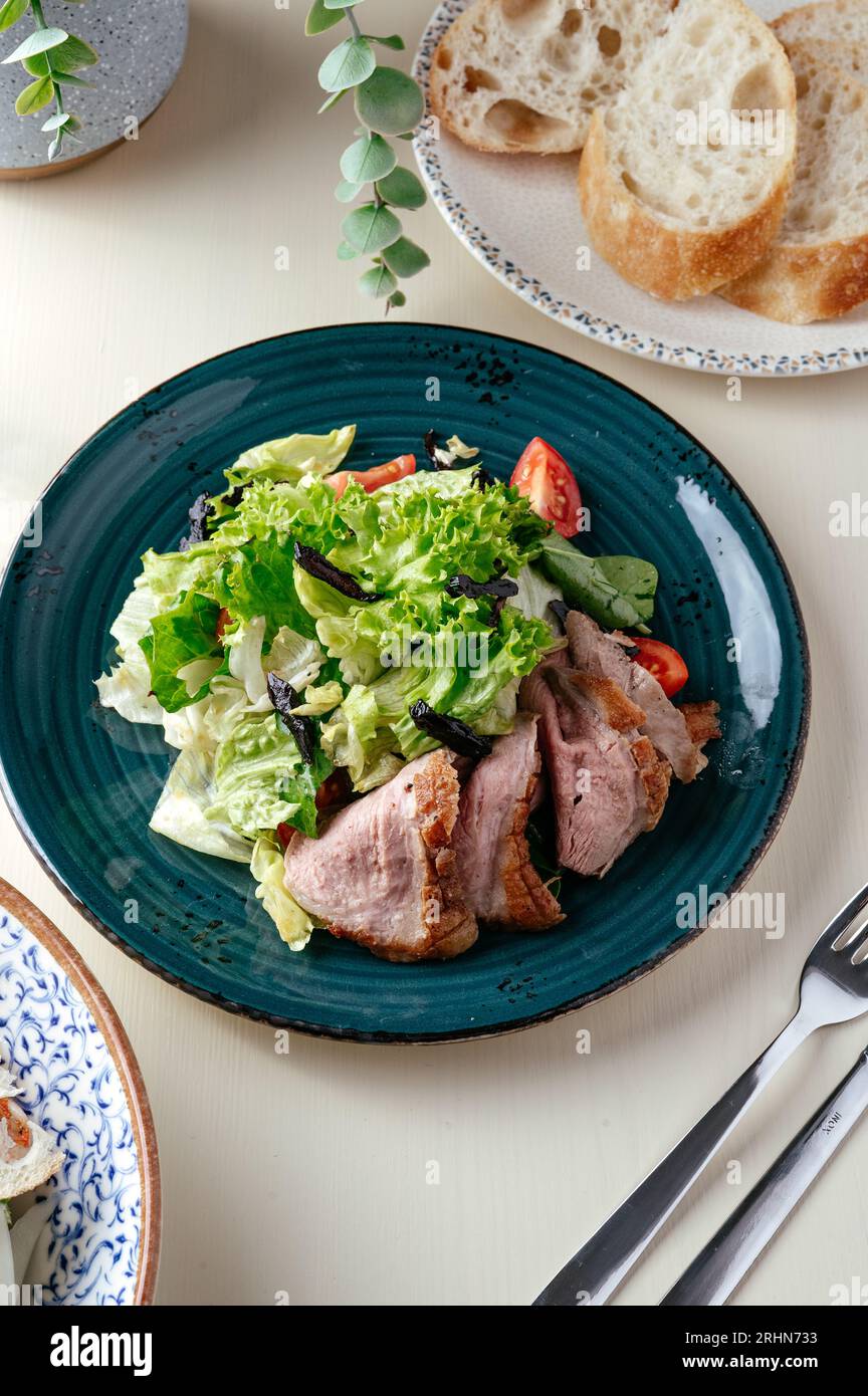 steak salad in a blue plate. restaurant menu Stock Photo - Alamy