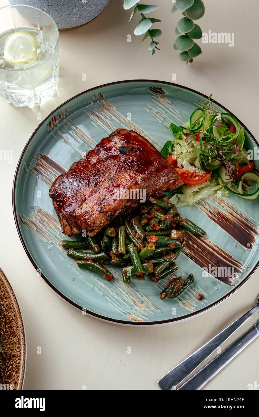 grilled pork ribs with barbecue sauce. restaurant menu Stock Photo - Alamy