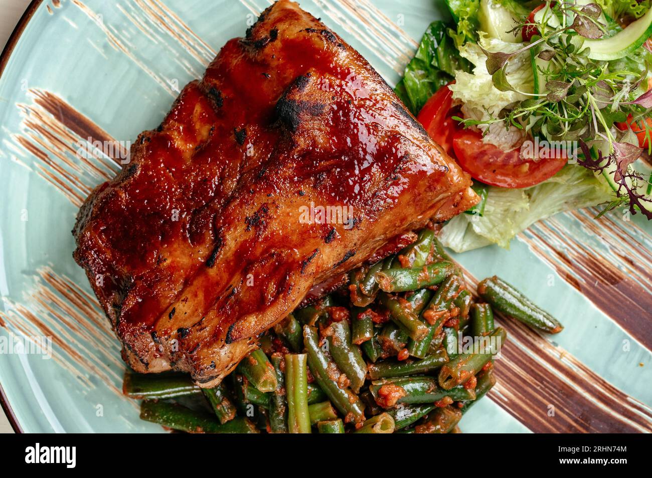 grilled pork ribs with barbecue sauce. restaurant menu Stock Photo - Alamy