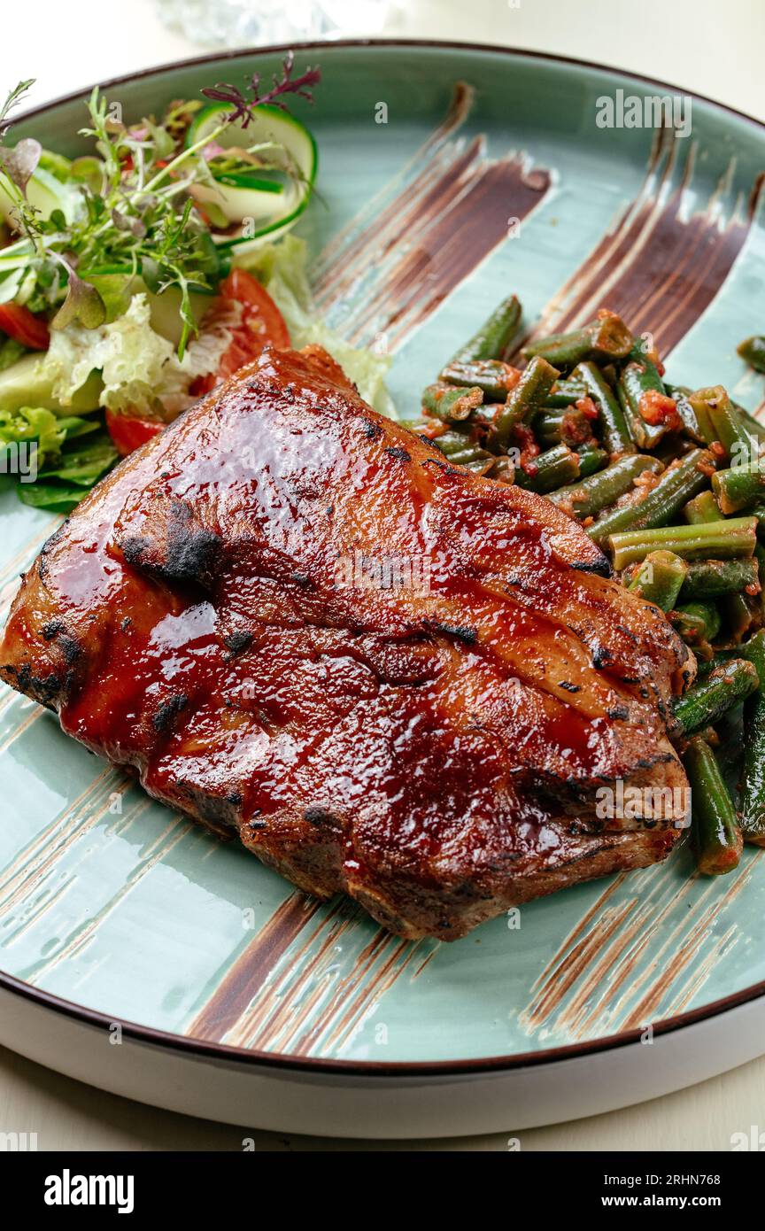 grilled pork ribs with barbecue sauce. restaurant menu Stock Photo - Alamy