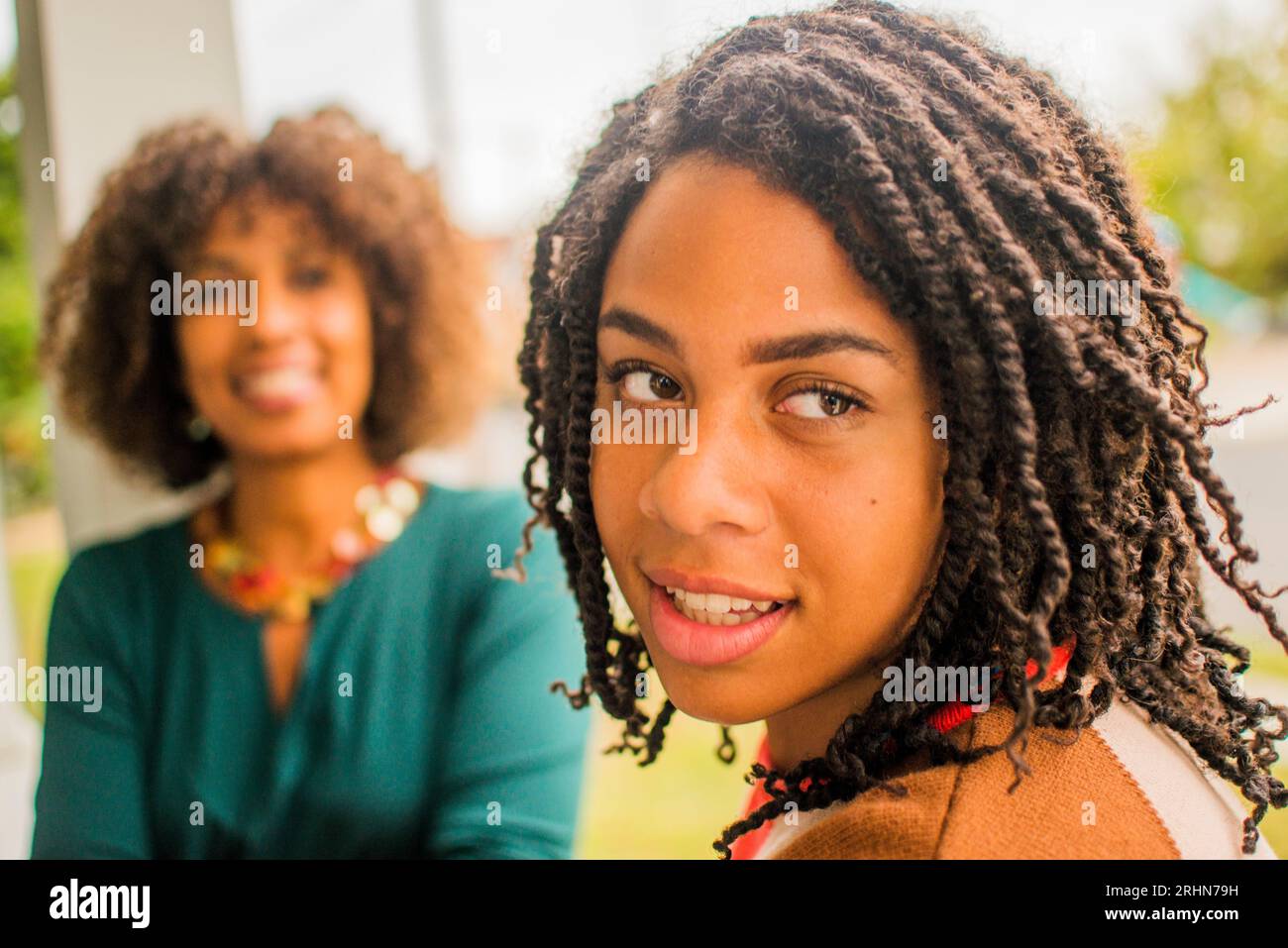 Black mother and daughter portraits on porch Stock Photo - Alamy