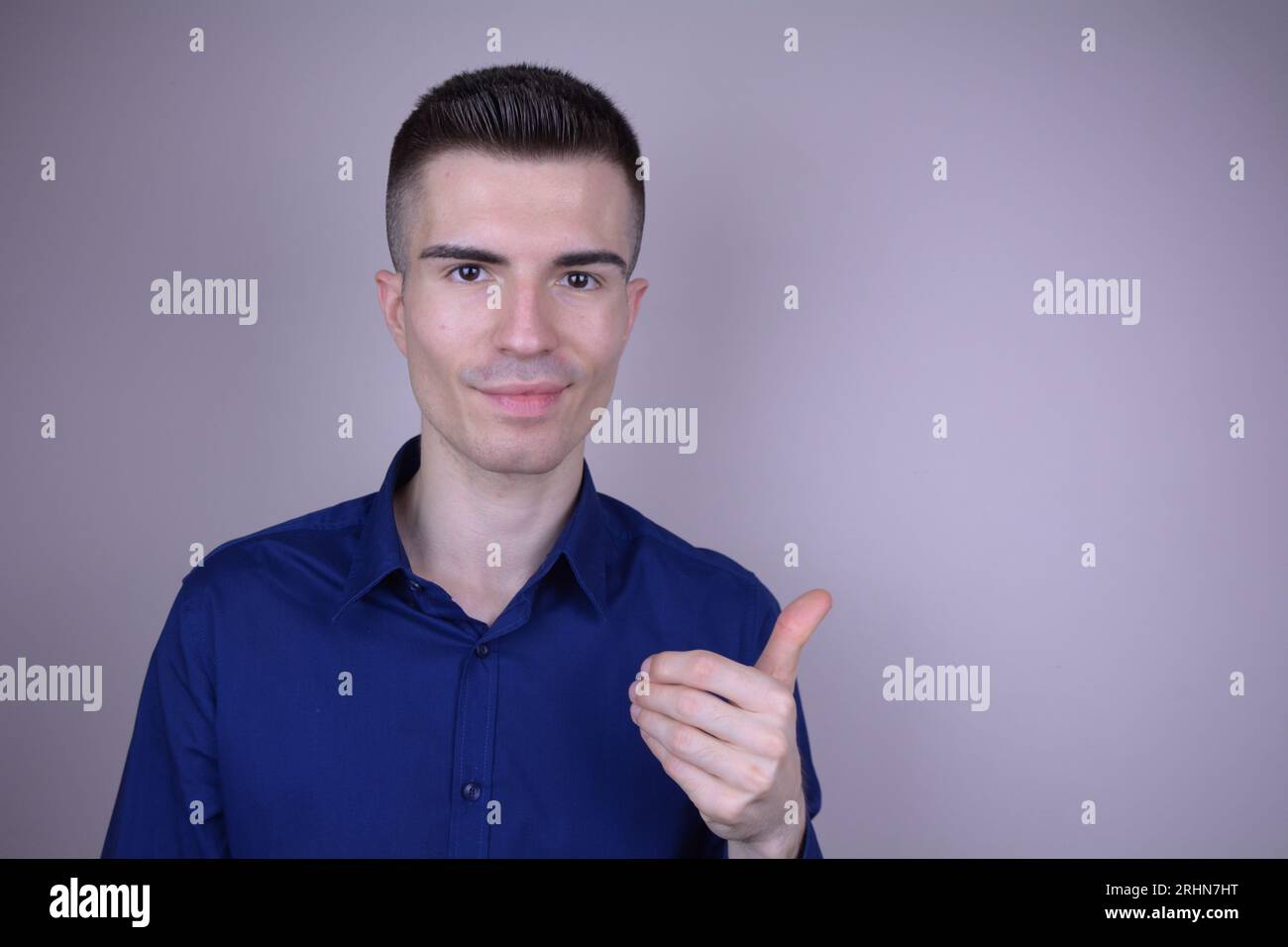 Elegant and Handsome Young Caucasian Man Holding Invisible Object on ...