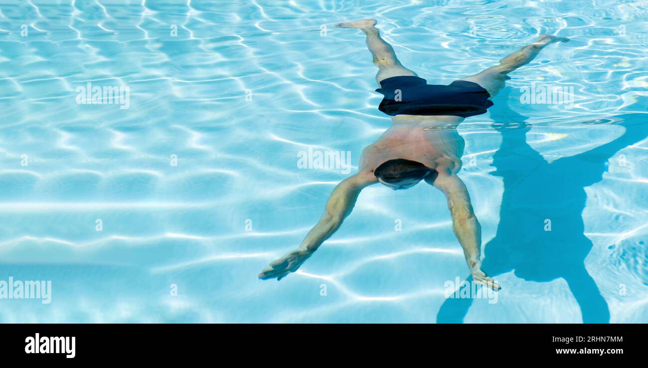 Blurred man swimming under the water in swimming pool in resort Stock ...