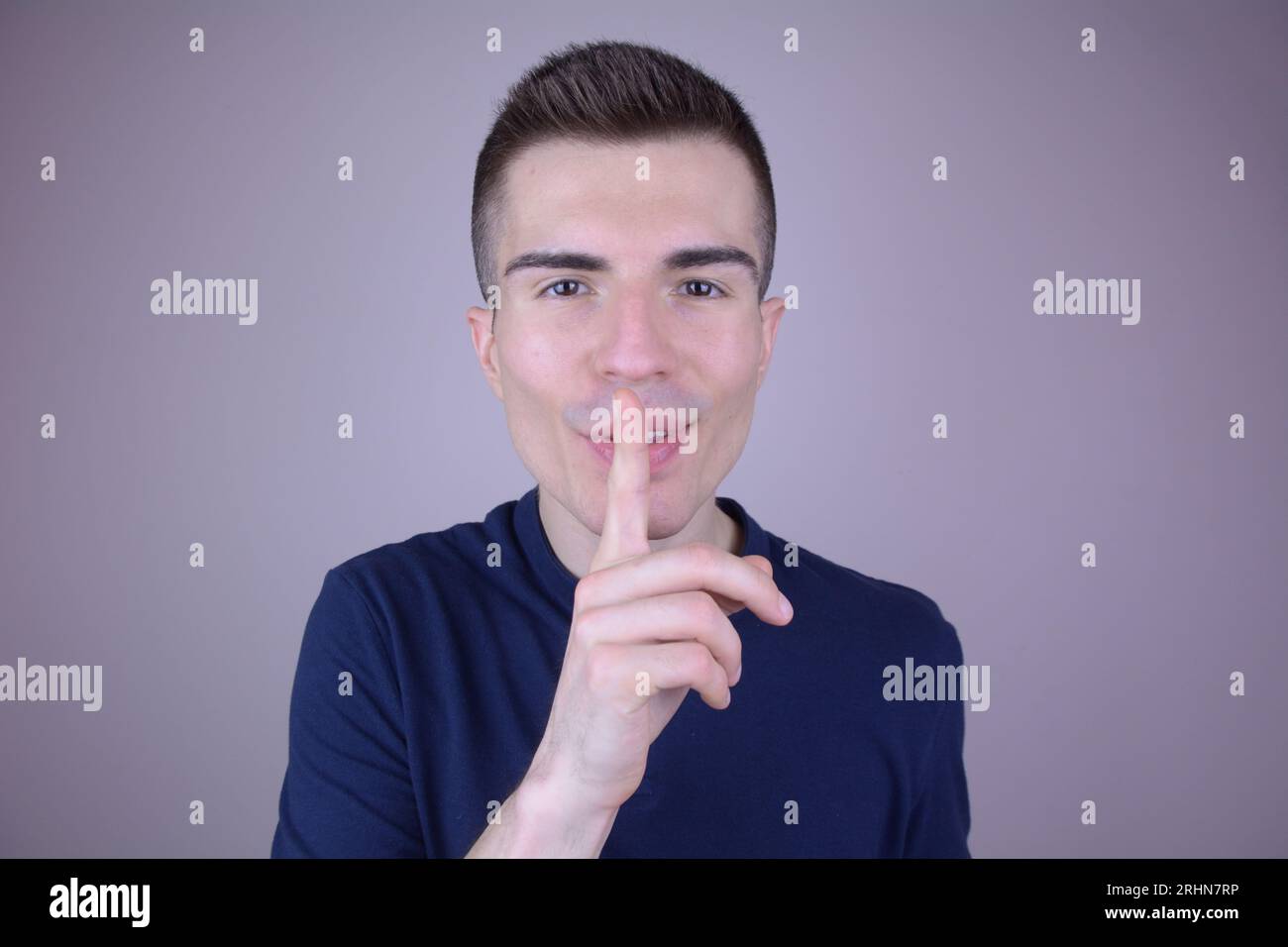 Smiling Caucasian Man Makes "Shh" Gesture with Finger to Lips on ...