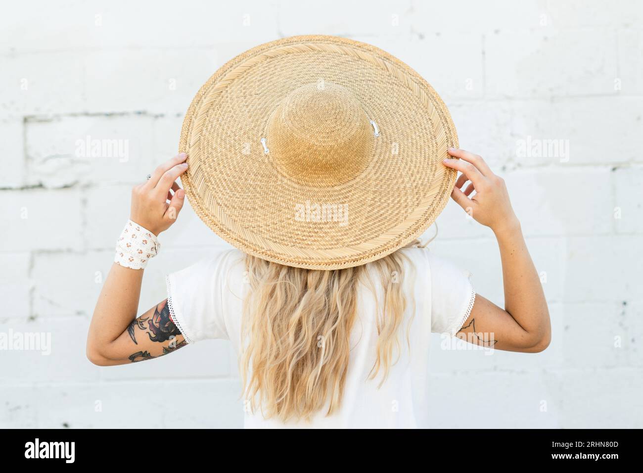 A woman wearing a large wicker hat Stock Photo - Alamy