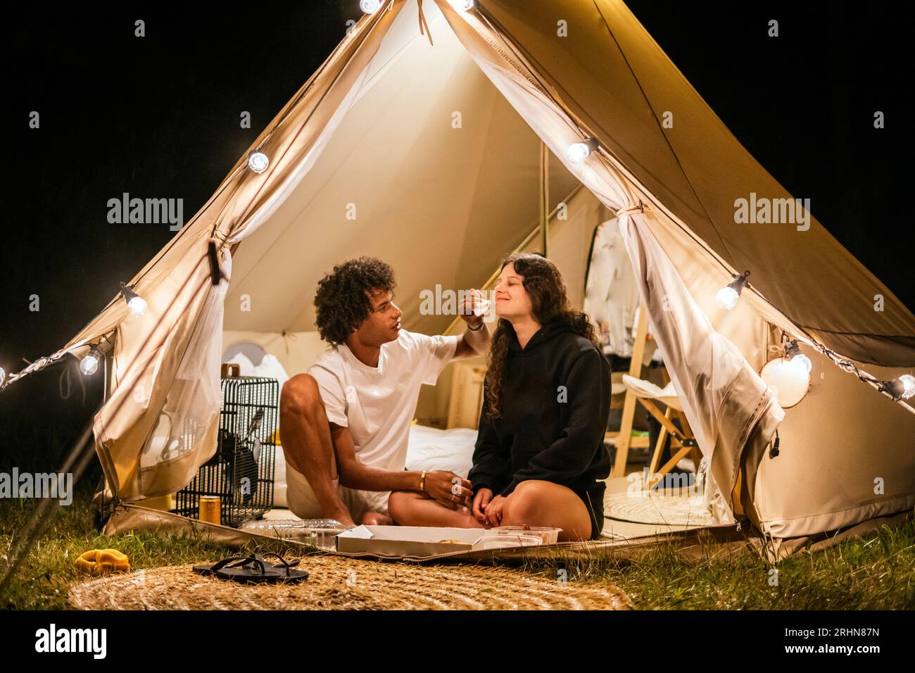 couple in love eating pizza in a camping tent Stock Photo - Alamy