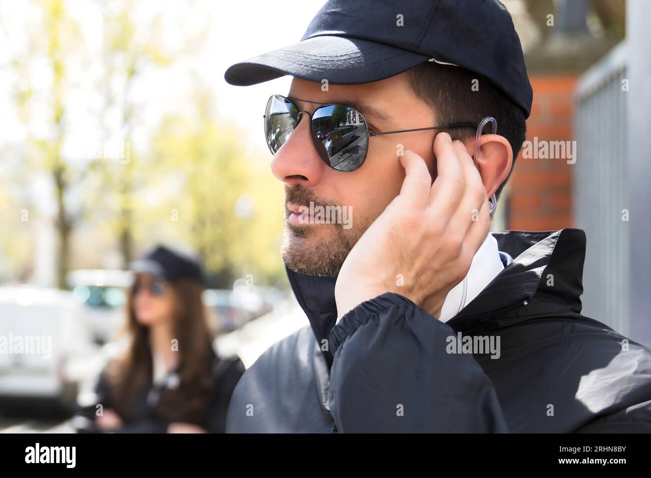 Close-up Of A Young Male Security Guard Listening With Earpiece Stock ...