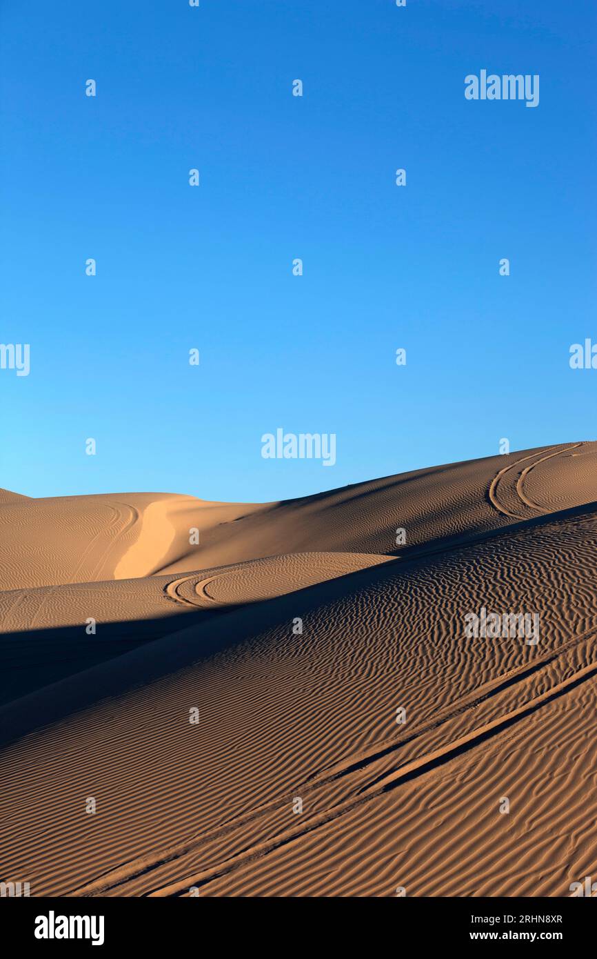 Sand dunes with wheel ruts and patterns in sand vertical Stock Photo ...
