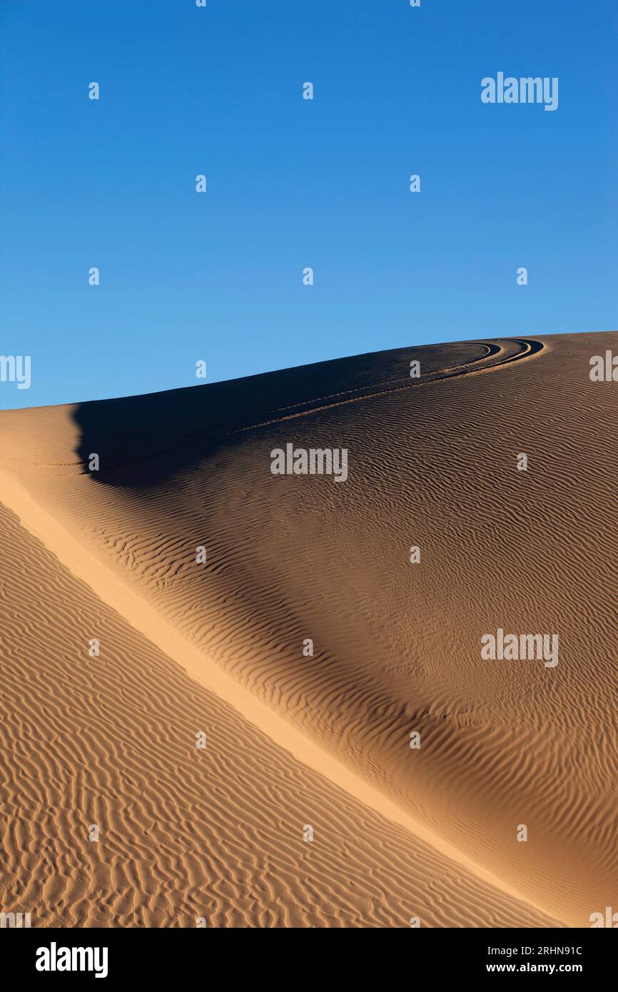 Rolling sand dunes with wheel ruts and patterns vertical Stock Photo ...