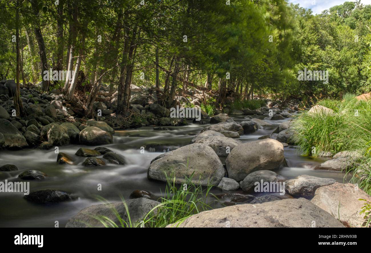 Water blurred from movement flowing over rocky stream bed Stock Photo ...