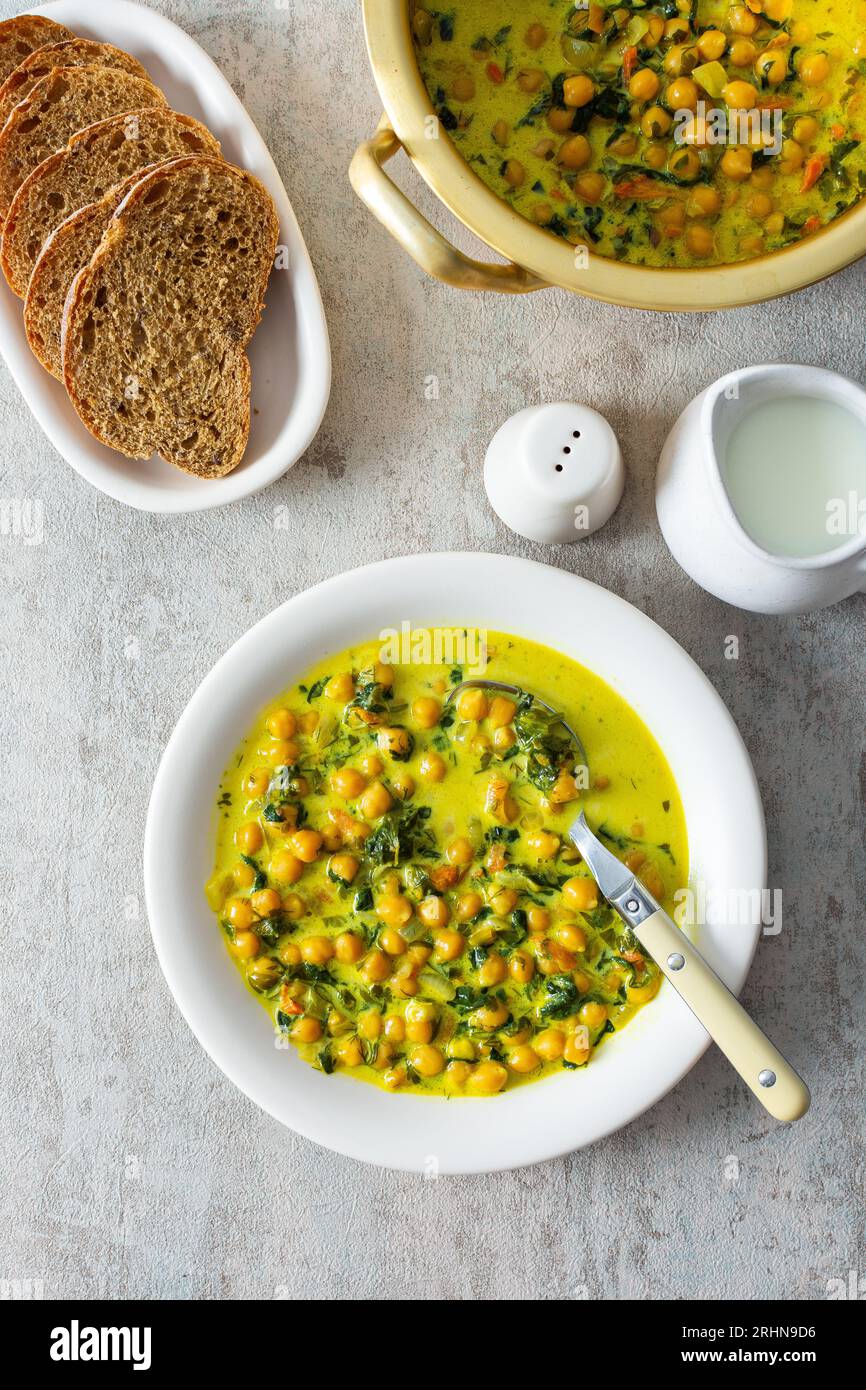 Healthy tasty lunch, soup with chickpeas and spinach, with spices and ...