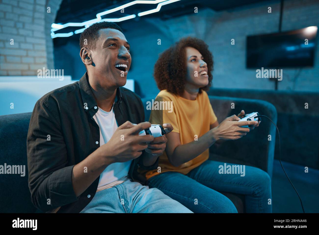 A couple in love is playing a console Stock Photo - Alamy