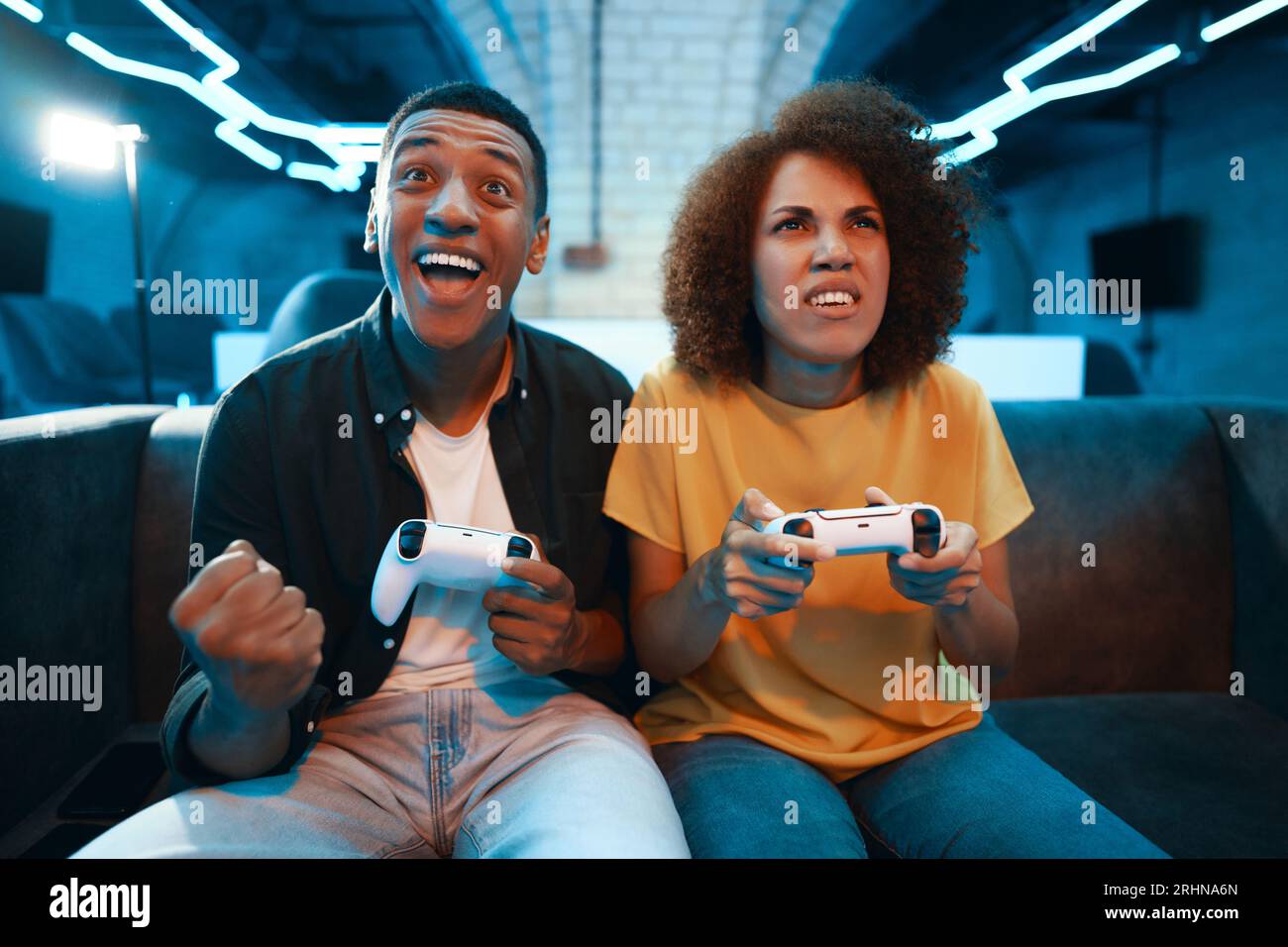 A couple in love is playing a console Stock Photo - Alamy