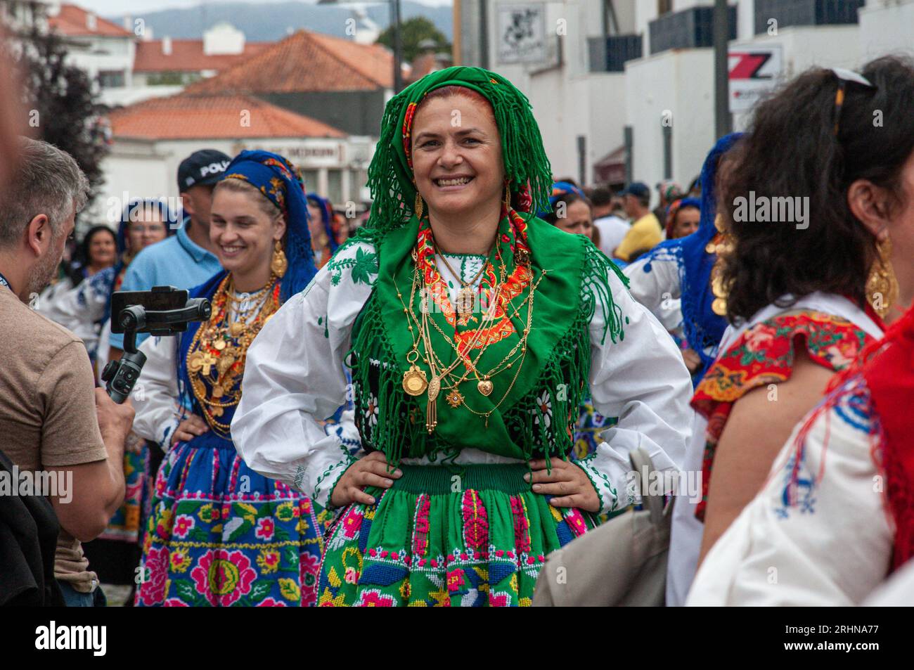 Women present jewelry and traditional costumes at Mordomia Parade, one ...