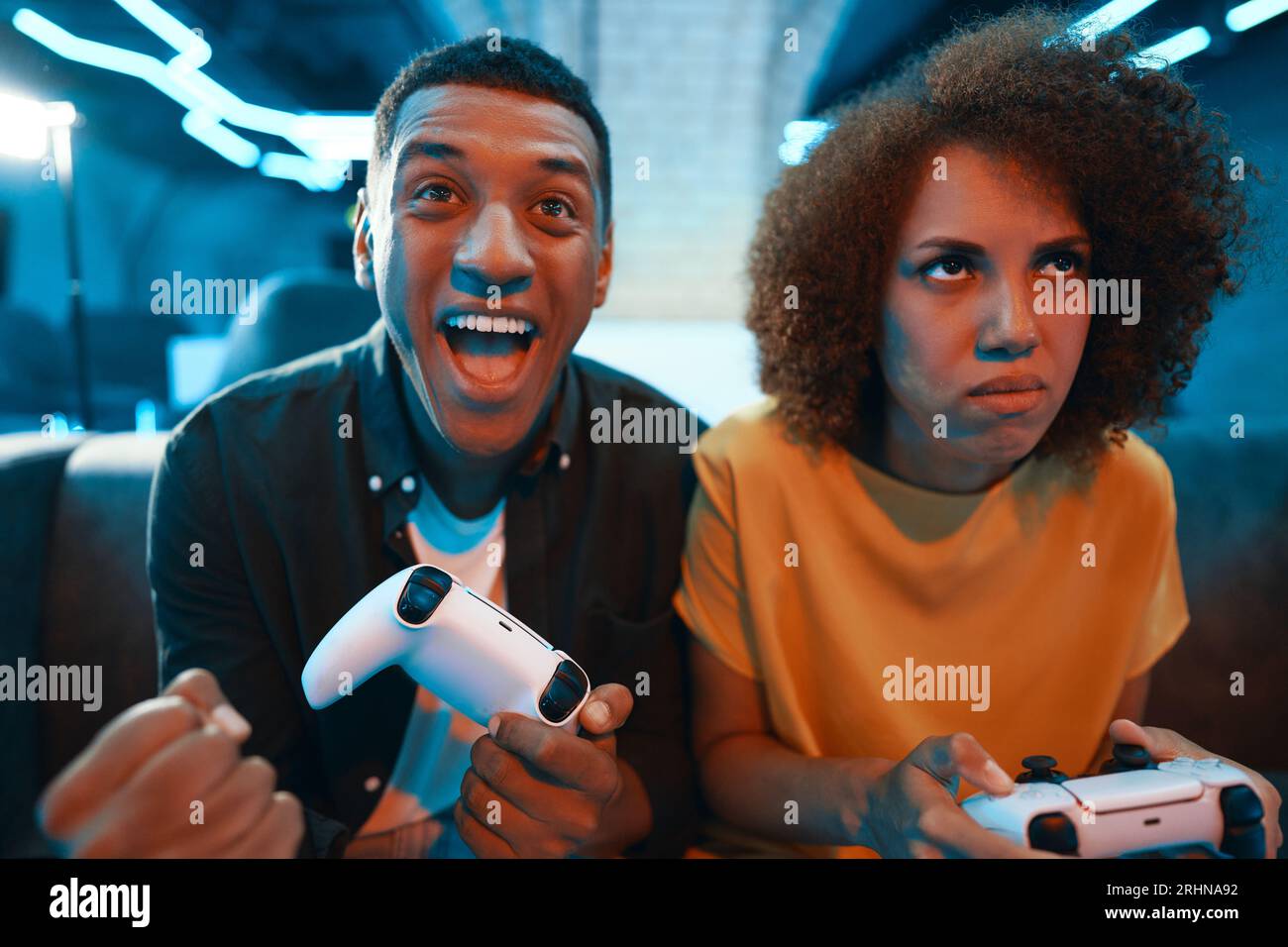 A couple in love is playing a console Stock Photo - Alamy