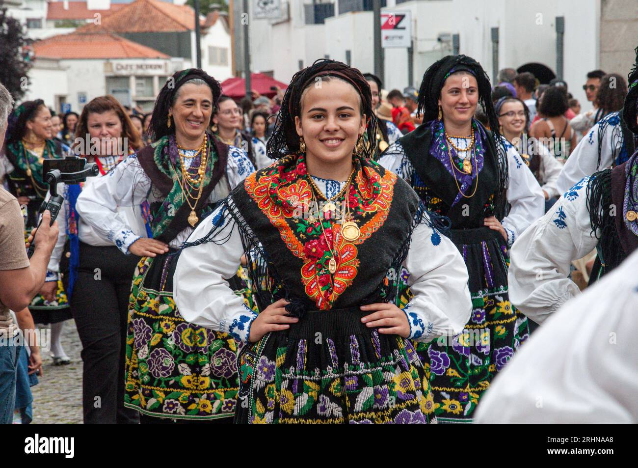 Women present jewelry and traditional costumes at Mordomia Parade, one ...