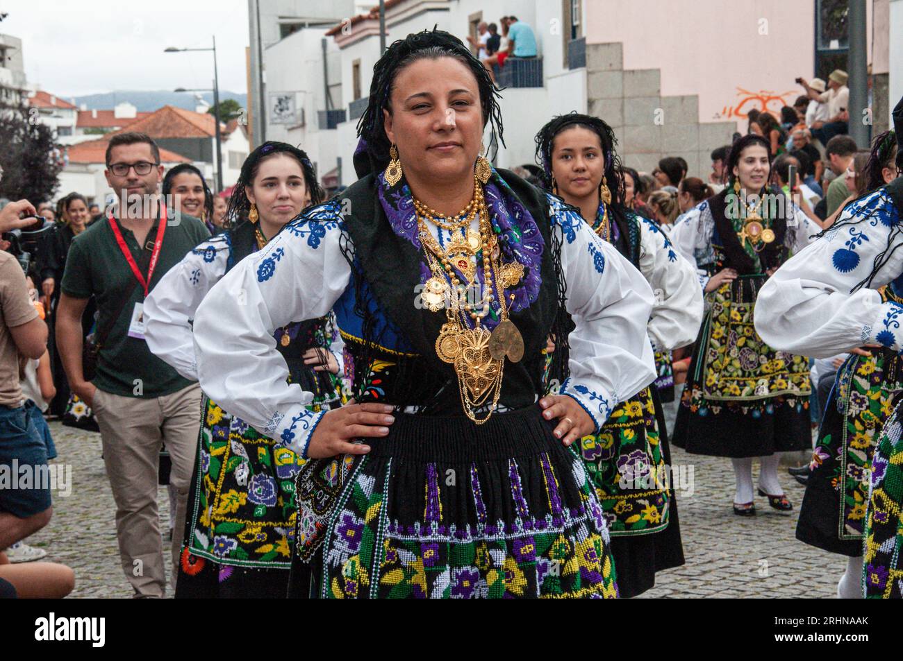 Women present jewelry and traditional costumes at Mordomia Parade, one ...