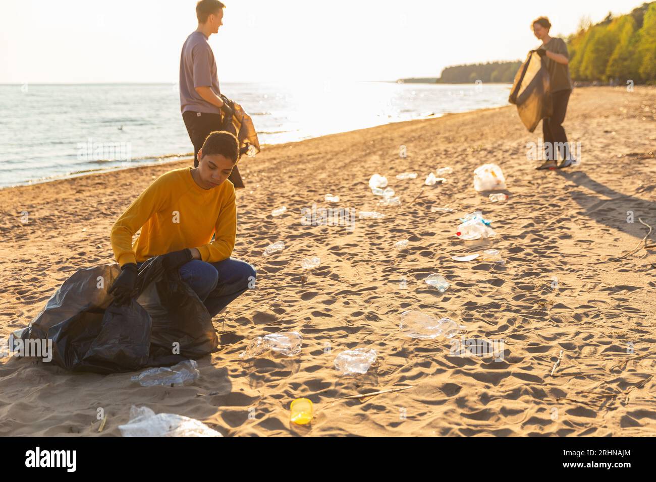 Earth day. Volunteers activists collects garbage cleaning of beach ...