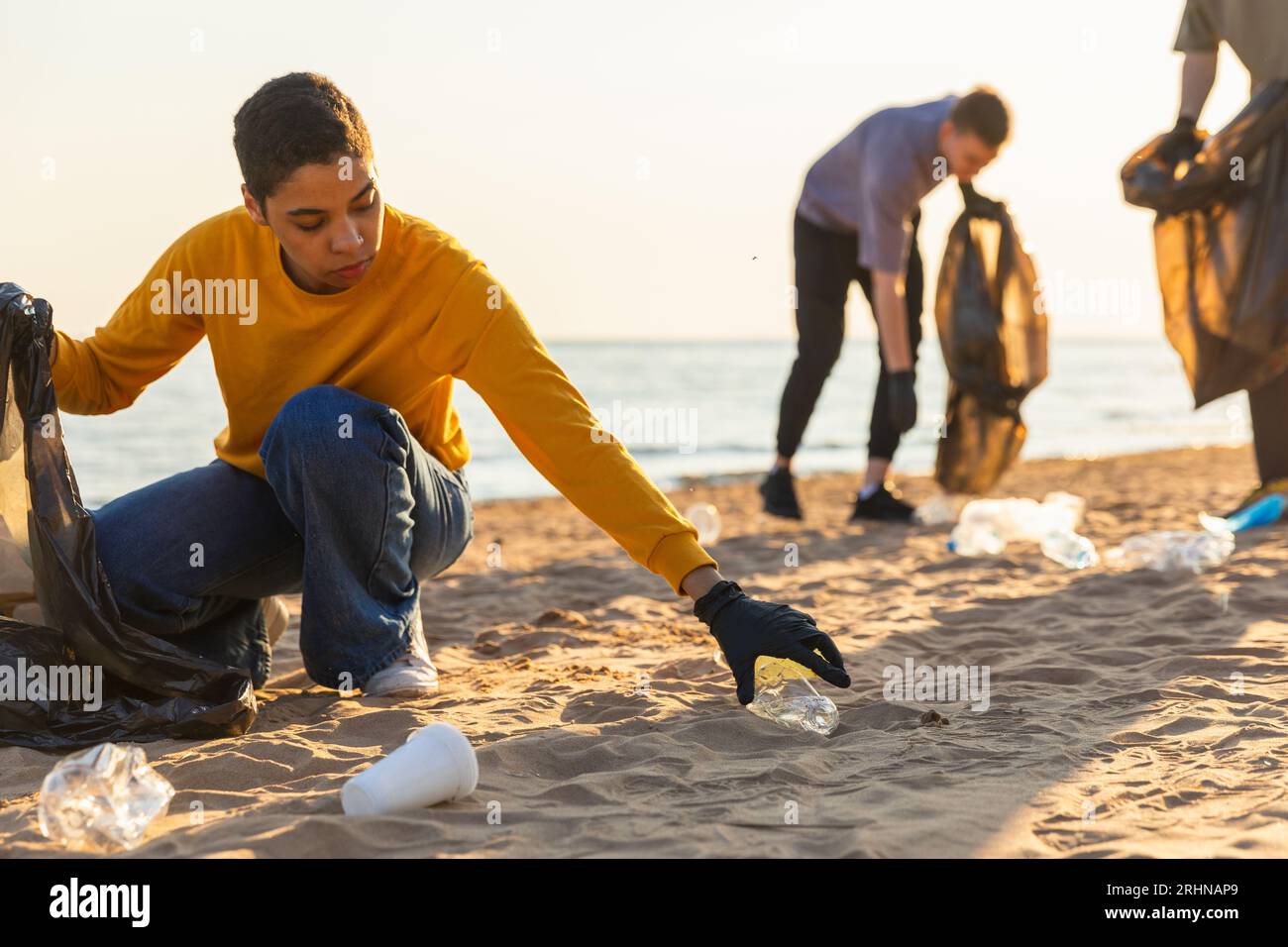 Earth day. Volunteers activists collects garbage cleaning of beach ...