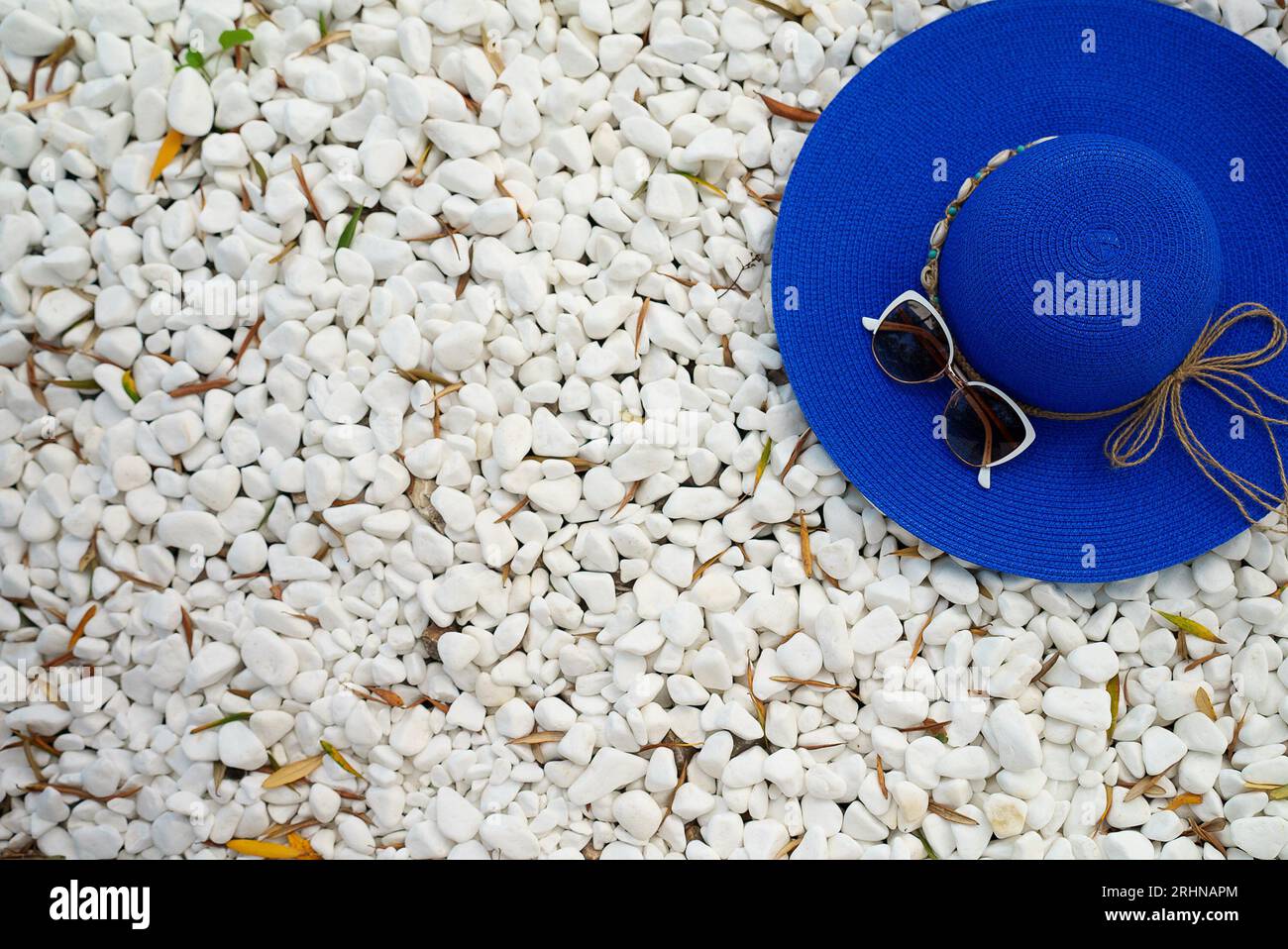 Blue hat with sunglasses lies on the rocks on the seashore Stock Photo ...