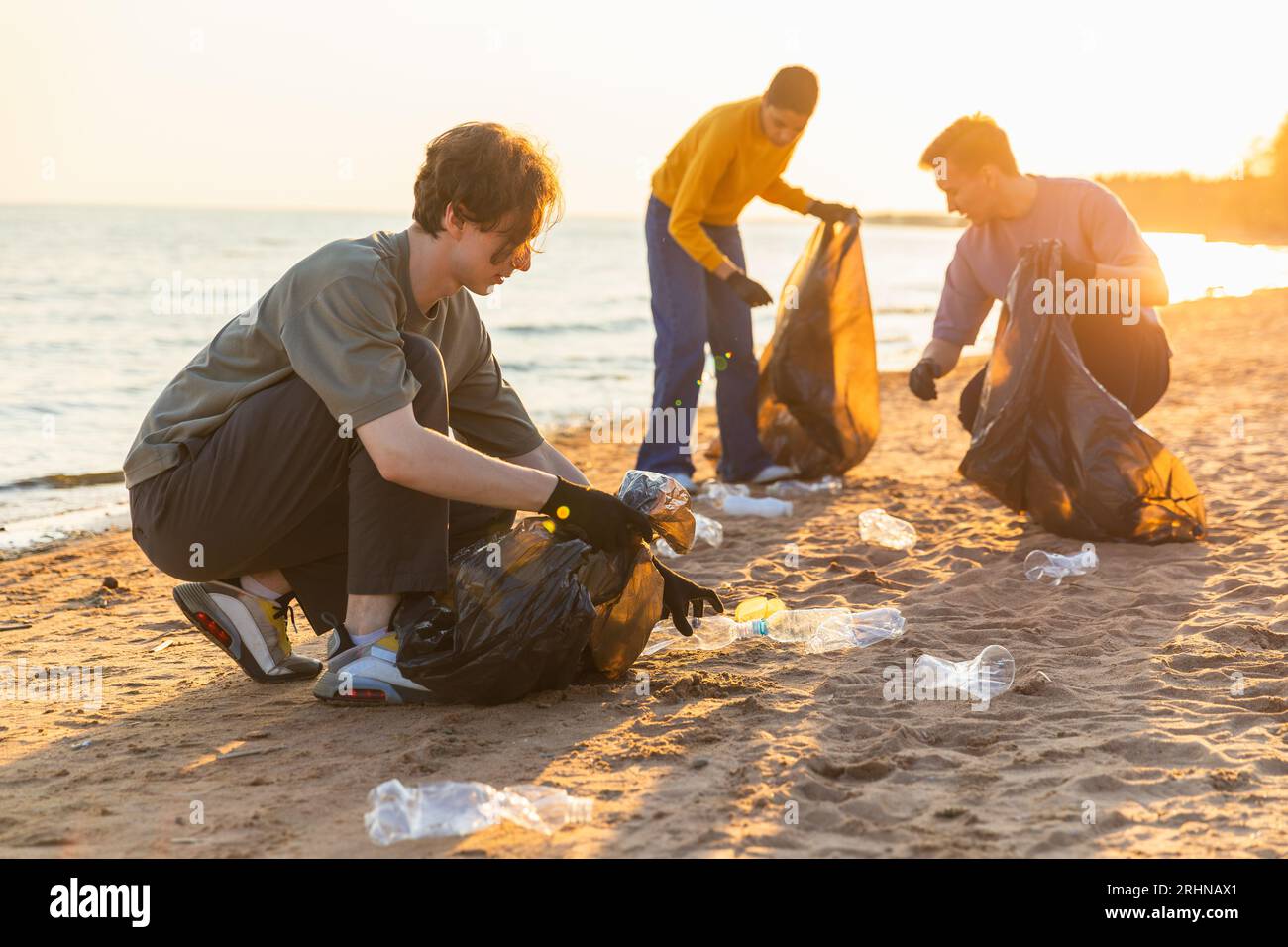 Earth day. Volunteers activists team collects garbage cleaning of beach ...