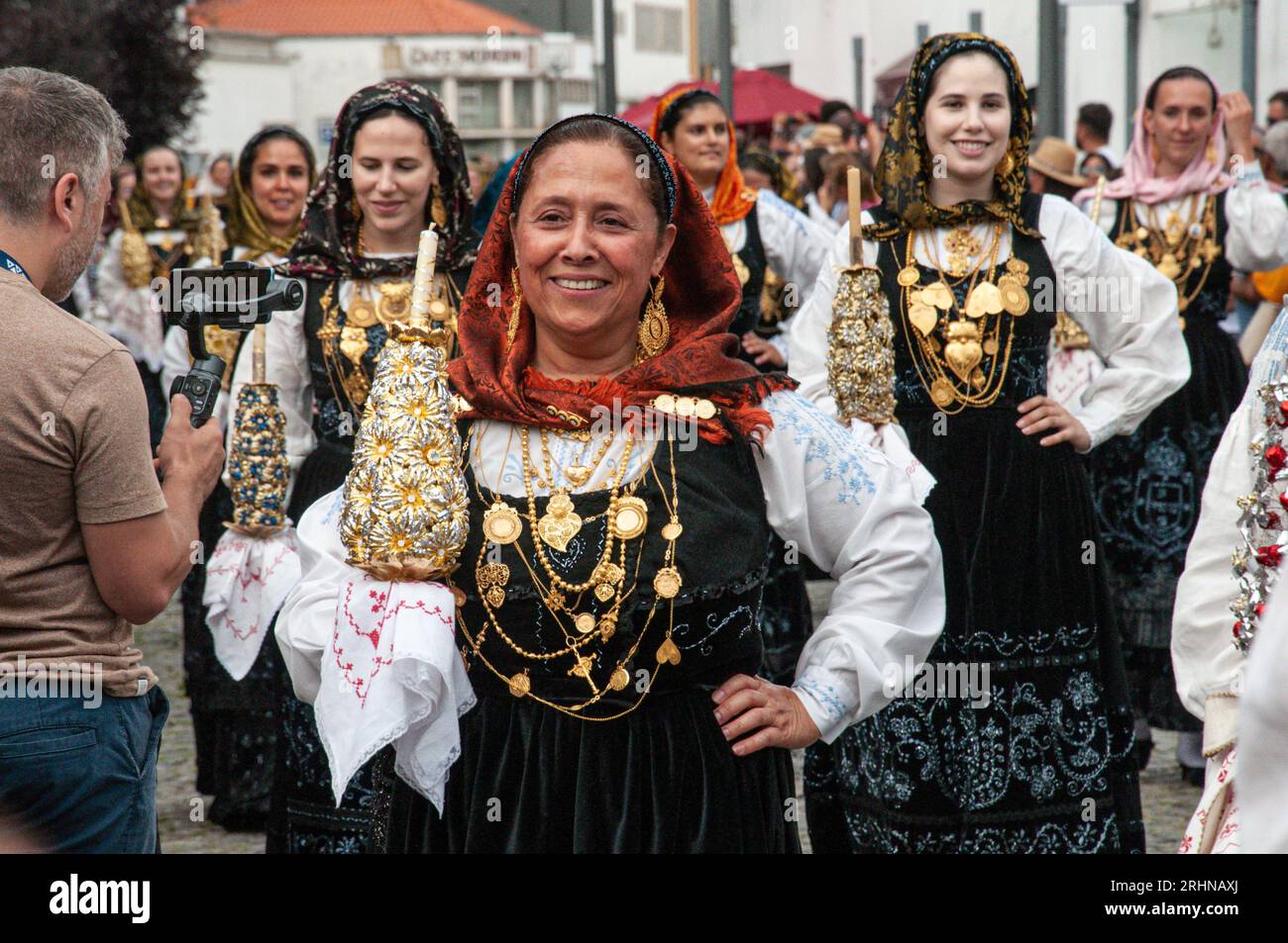 Women present jewelry and traditional costumes at Mordomia Parade, one ...