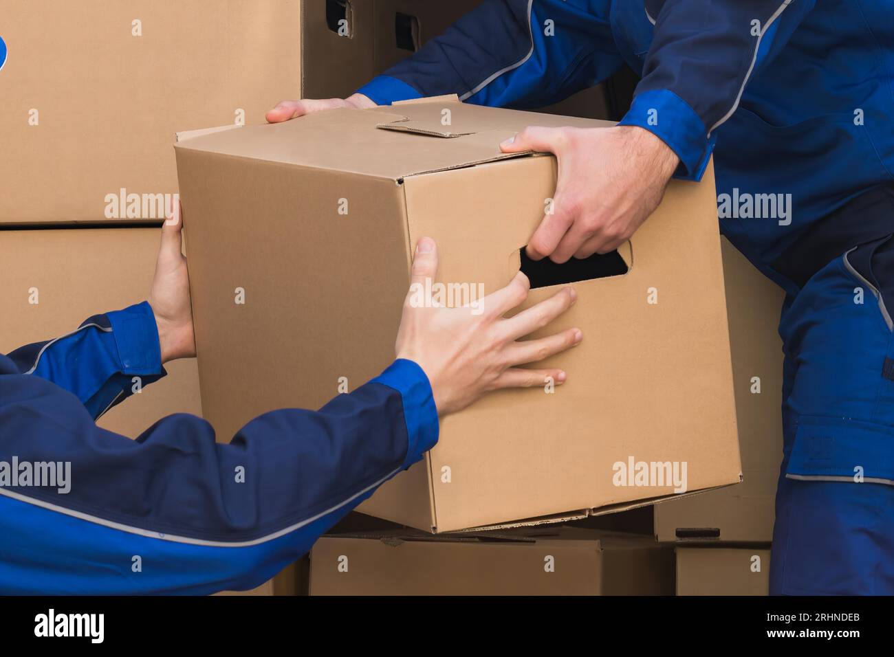 Young delivery men unloading cardboard boxes from truck Stock Photo - Alamy
