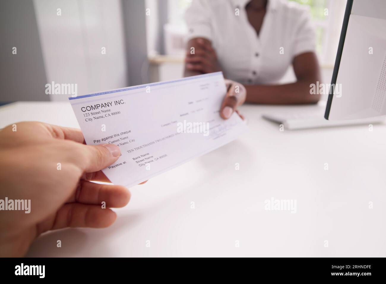 African Giving Cheque. Hand Holding Insurance Check Stock Photo - Alamy