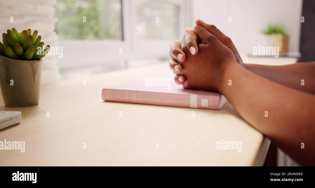 African American Black Christian. Bible In Prayer Hands Stock Photo - Alamy